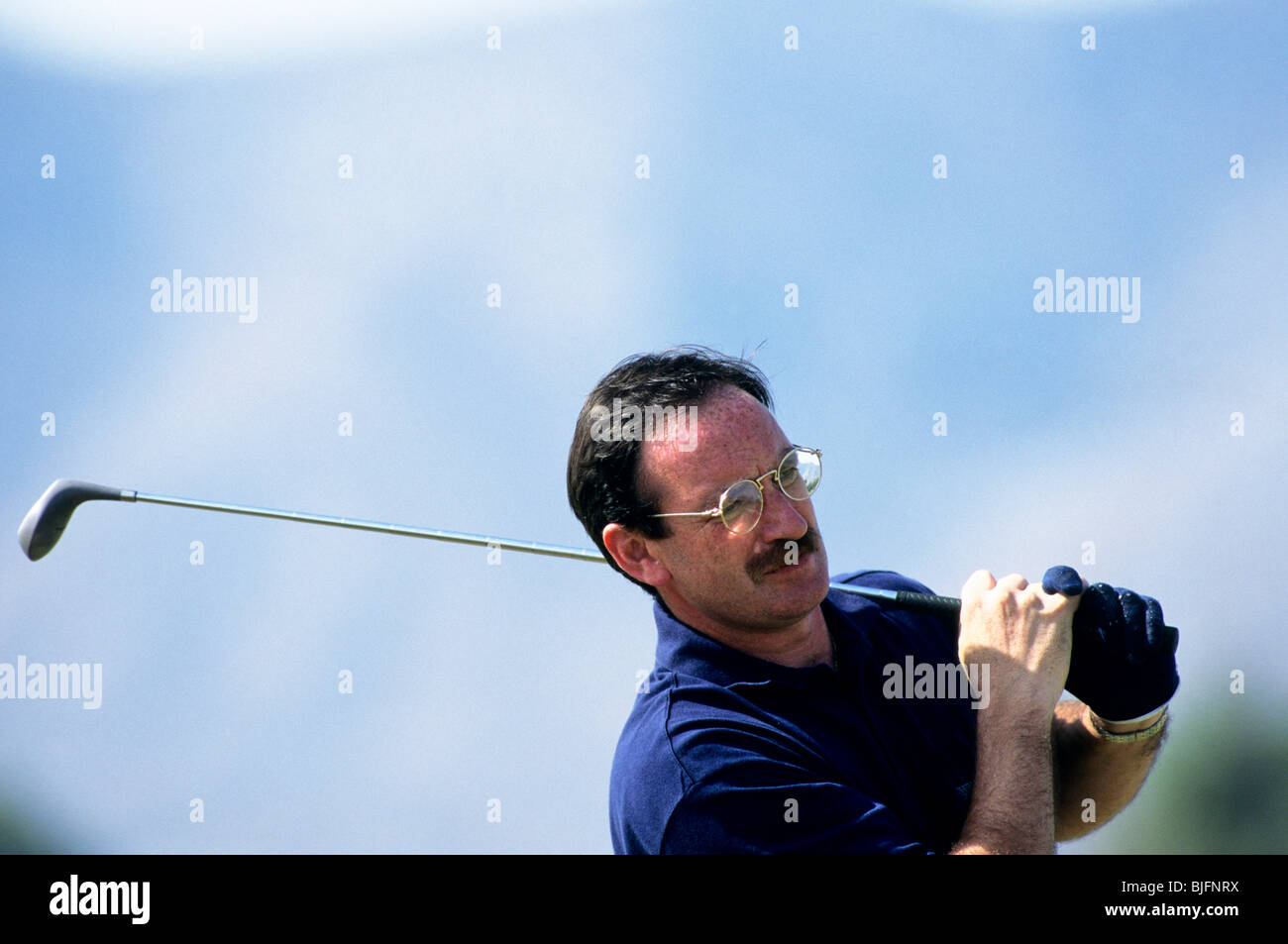 Golfer watching the flight of his golf ball Stock Photo - Alamy