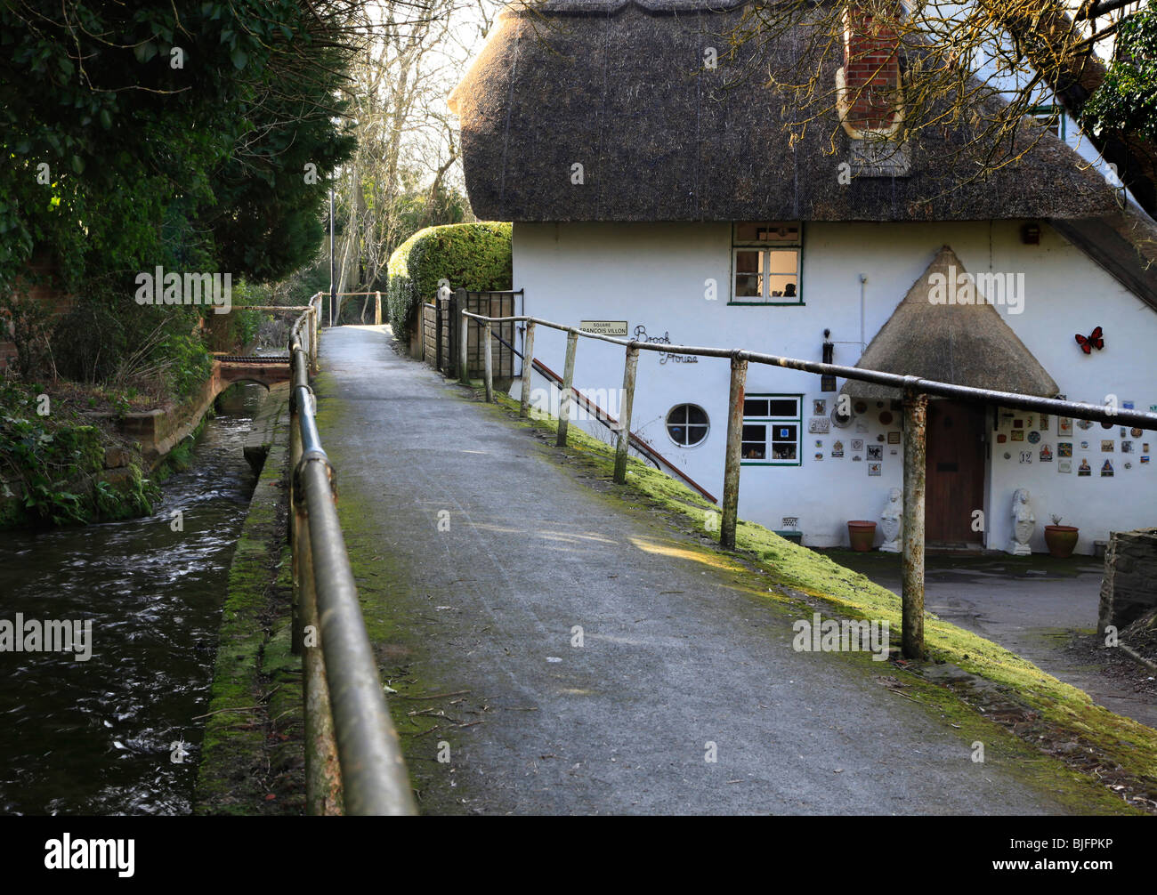 Footpath alongside the River Ray and a thatched cottage in The Pitchens ...