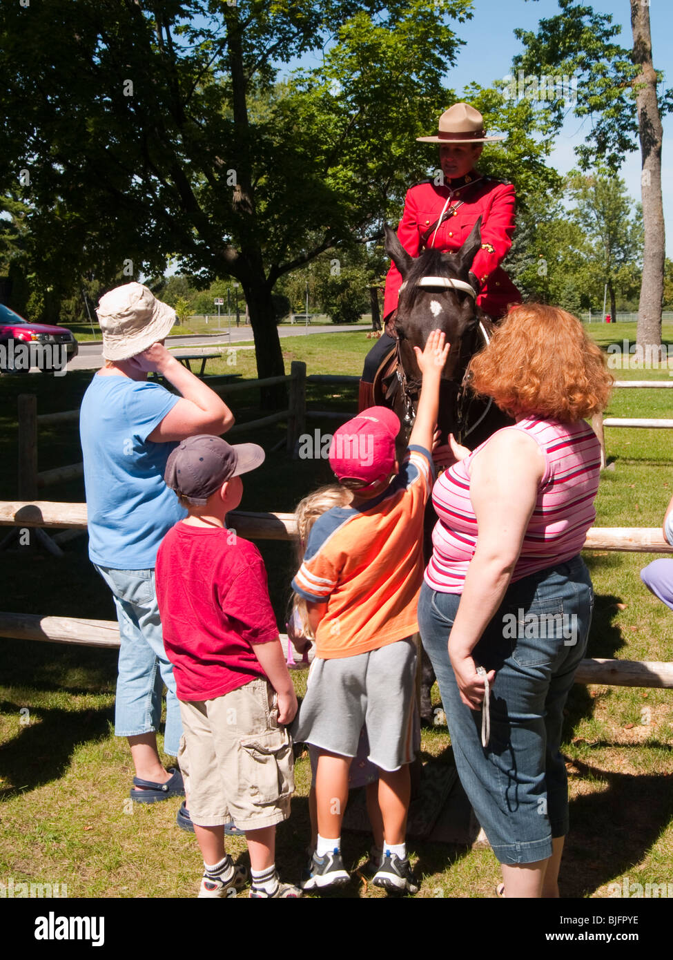 A mountie talking to visitors at the RCMP (Royal Canadian Mounted ...