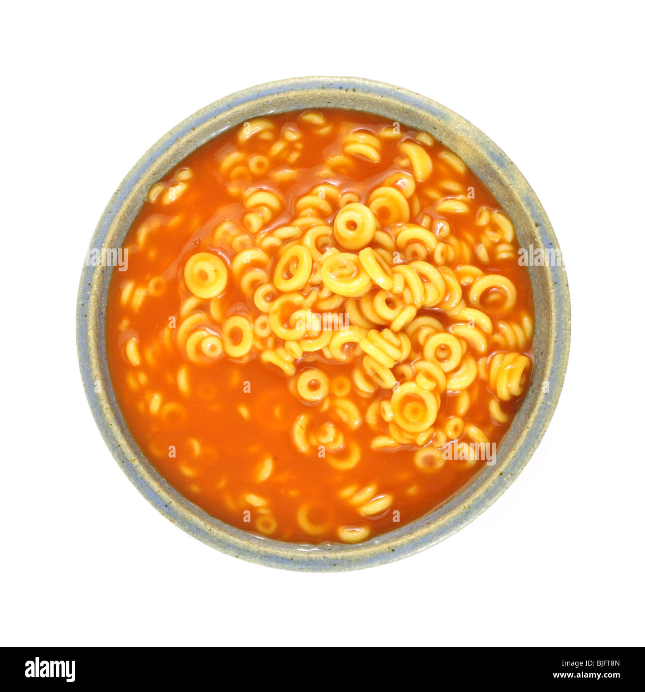 Tomato soup and pasta rings in old bowl Stock Photo - Alamy