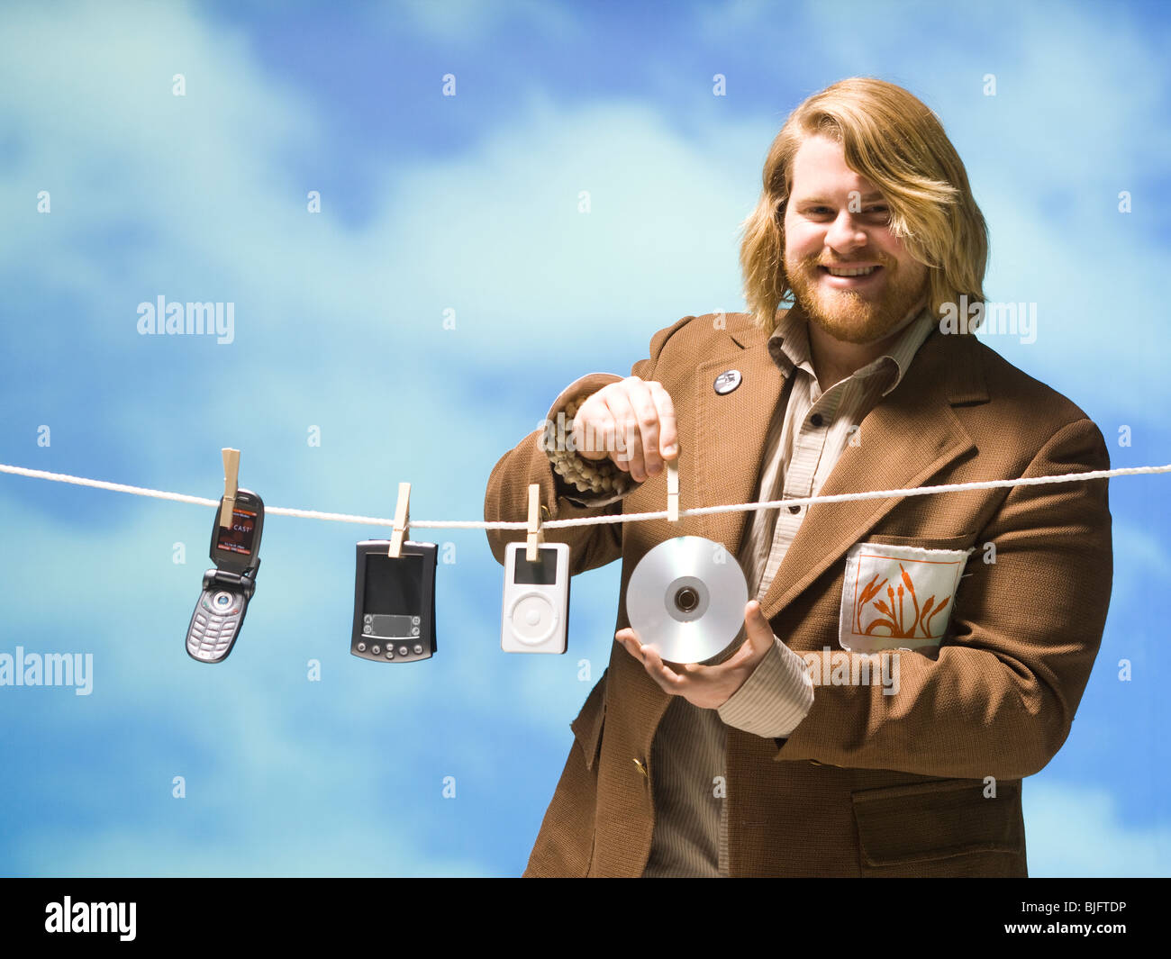 man hanging tech devices on a clothesline Stock Photo - Alamy