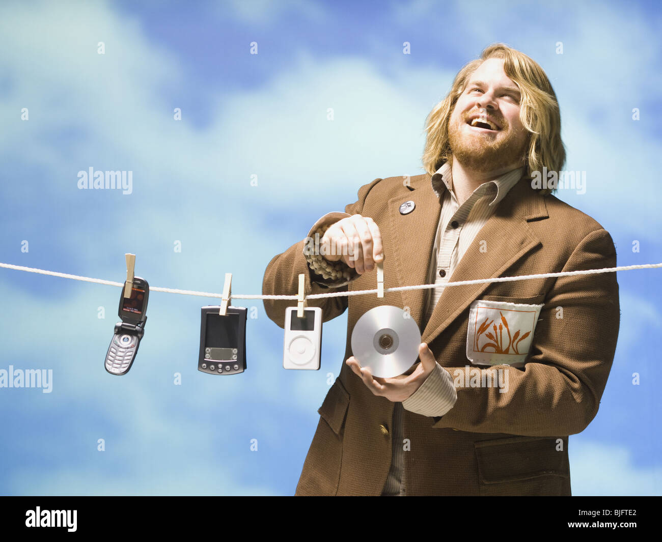 man hanging tech devices on a clothesline Stock Photo - Alamy