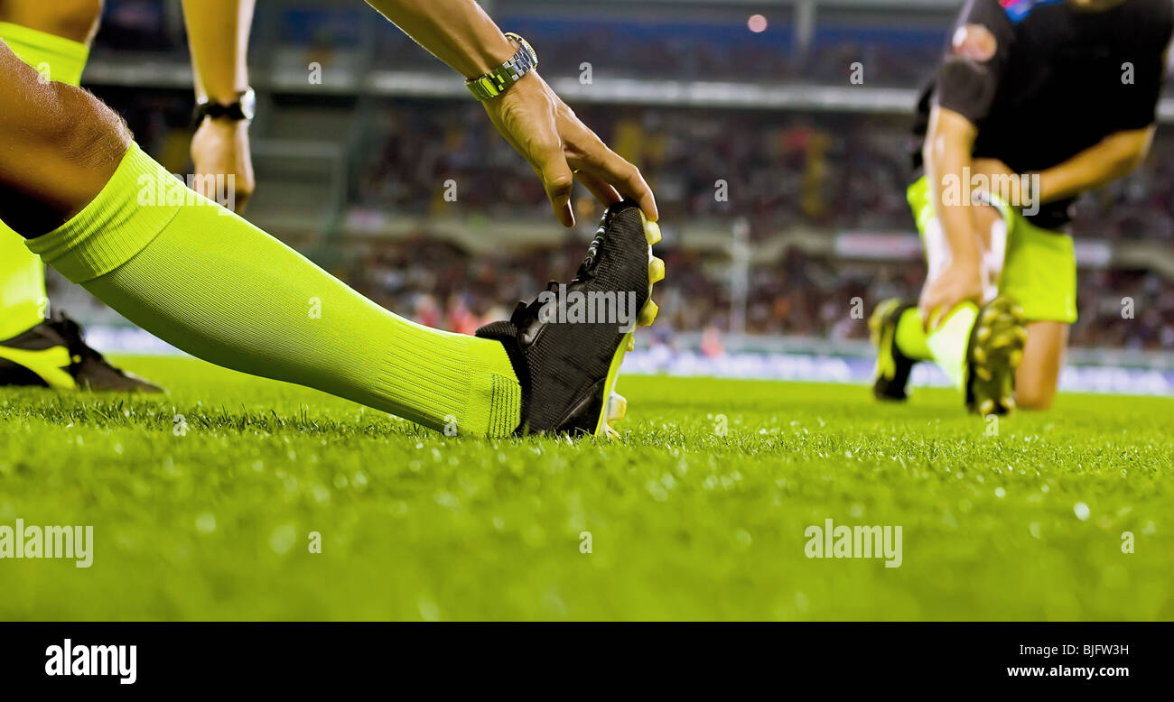 Football players warming up on the pitch Stock Photo - Alamy