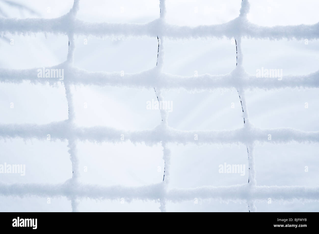 Closeup of a net cowered with snow Stock Photo - Alamy