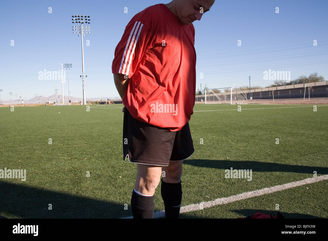 Football player on a pitch Stock Photo - Alamy