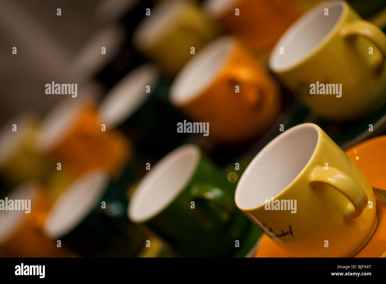 Stack of multi colored coffee mugs Stock Photo - Alamy