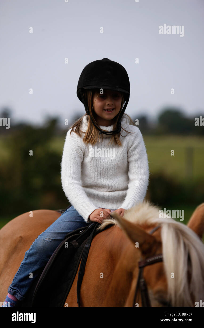 Young girl horse back riding Stock Photo - Alamy