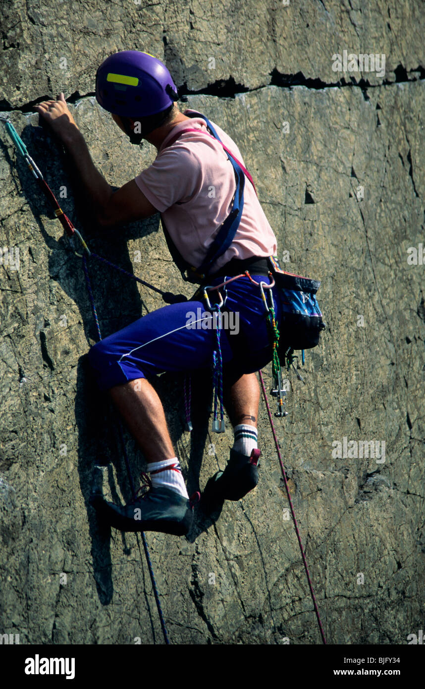Mountaineer scaling a rock face Stock Photo - Alamy