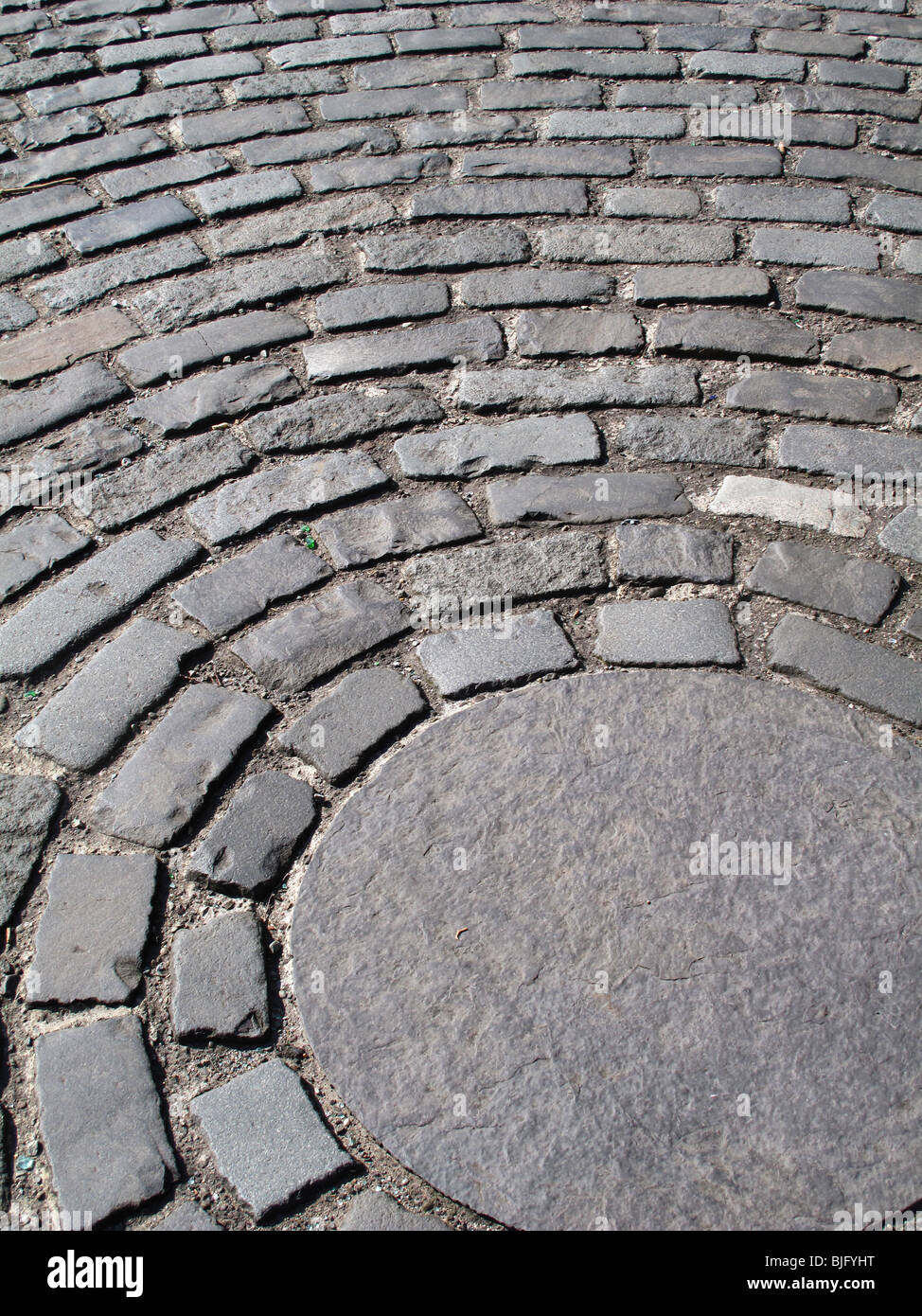 Granite setts in circular pattern Stock Photo - Alamy