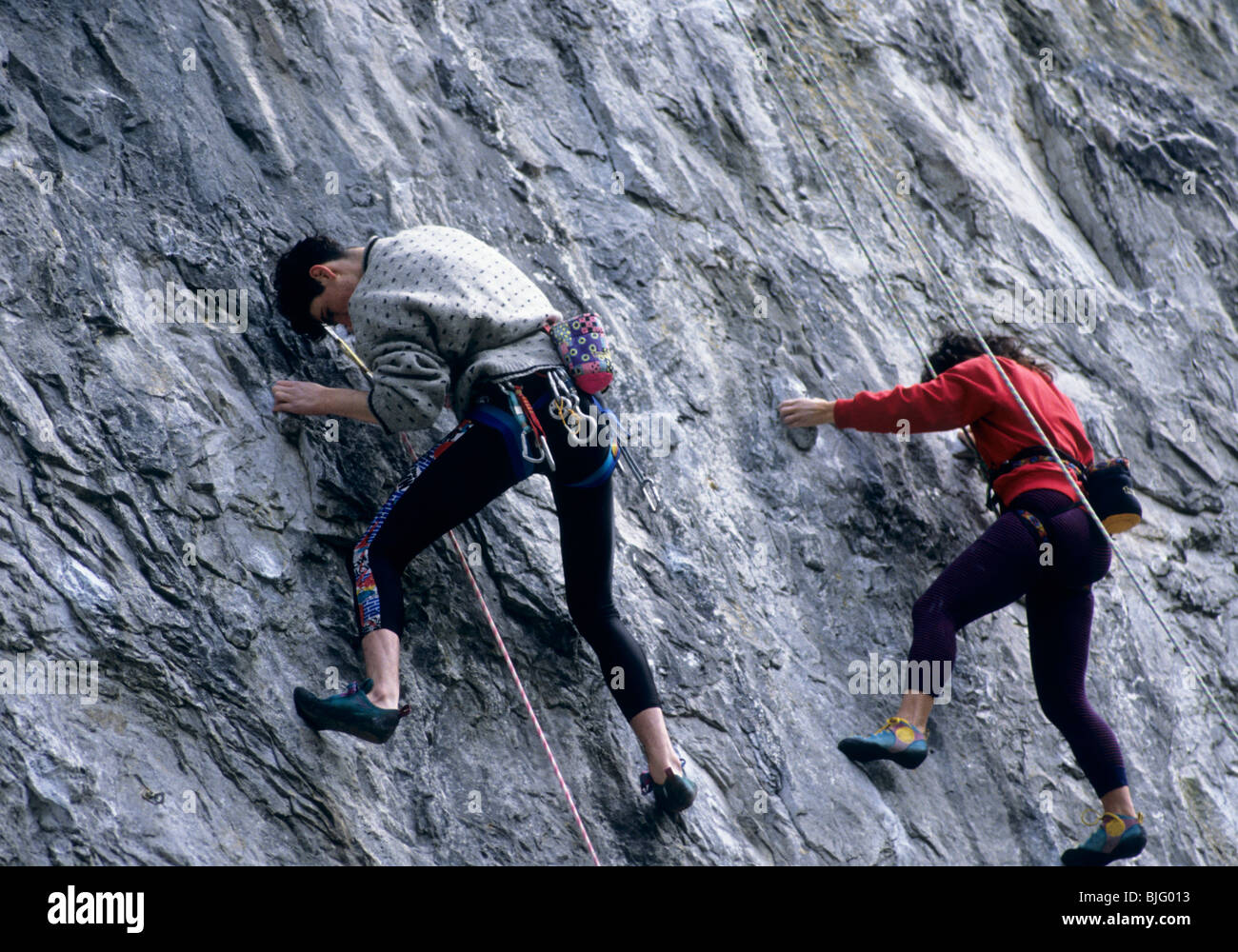 Mountaineers scaling a rock face Stock Photo - Alamy