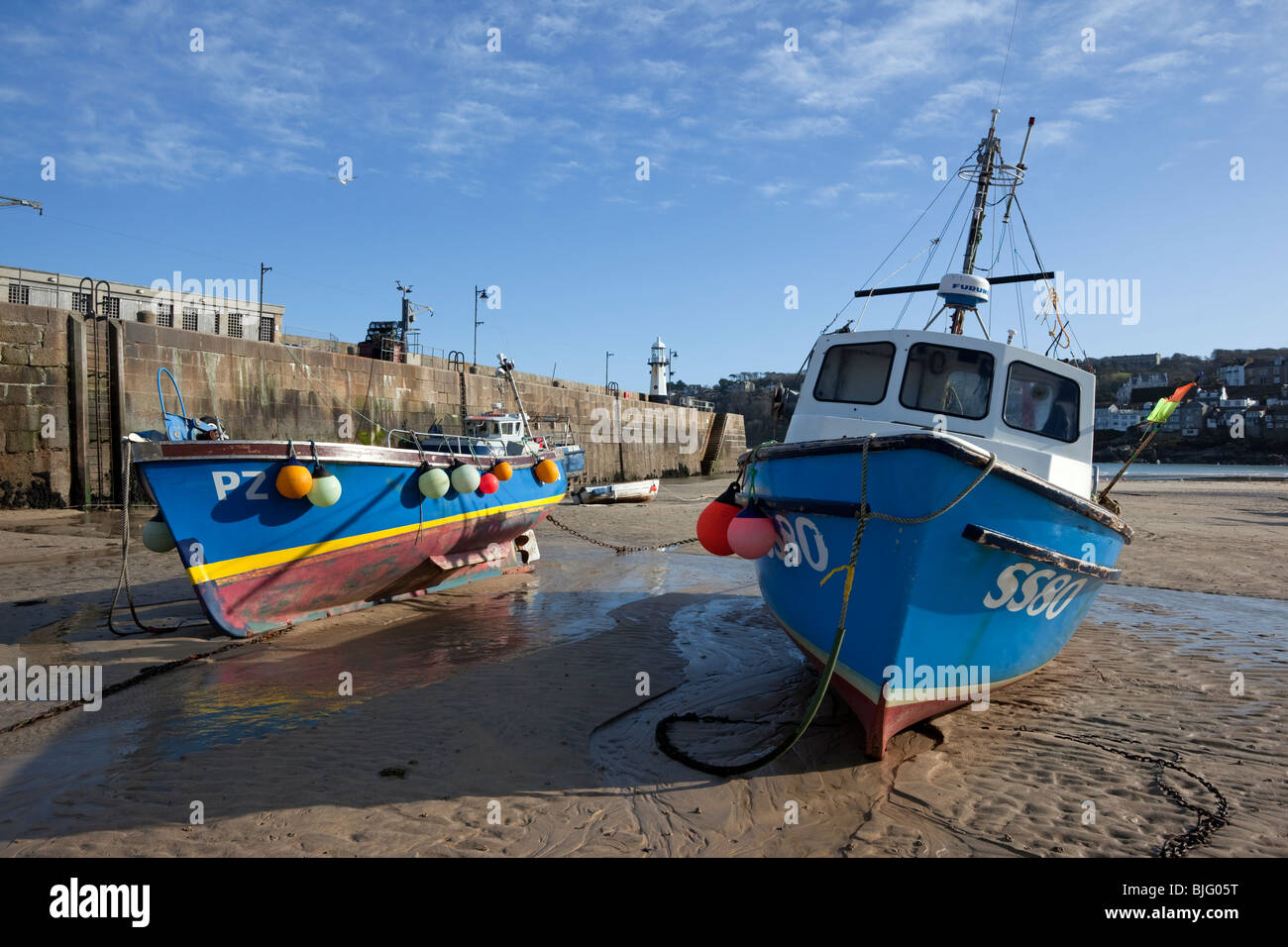 Two blue boats on the harbour beach in St. Ives, Cornwall England UK ...