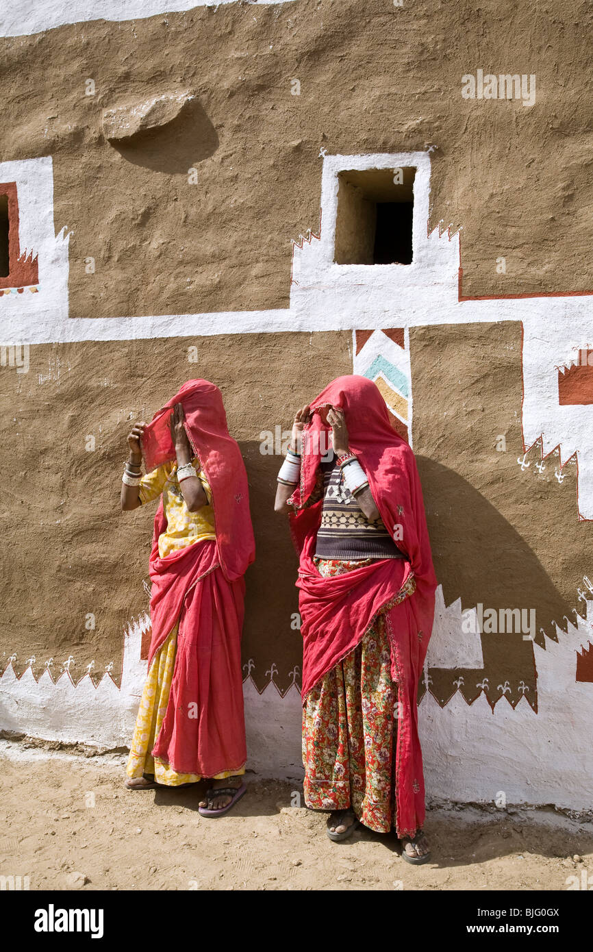 Indian women and traditional haveli (house). Khuri village. Rajasthan ...