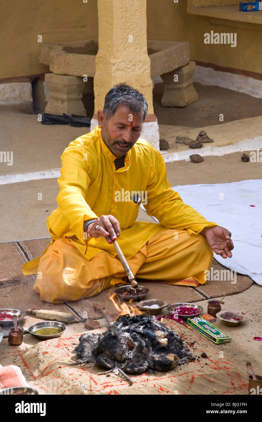 Hindu priest performing a ritual puja. Khuri village. Rajasthan. India ...
