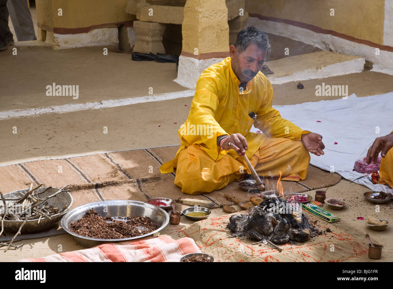 Hindu priest performing a ritual puja. Khuri village. Rajasthan. India ...
