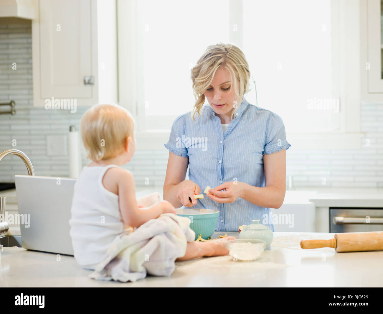 mother and baby girl cooking in the kitchen Stock Photo - Alamy