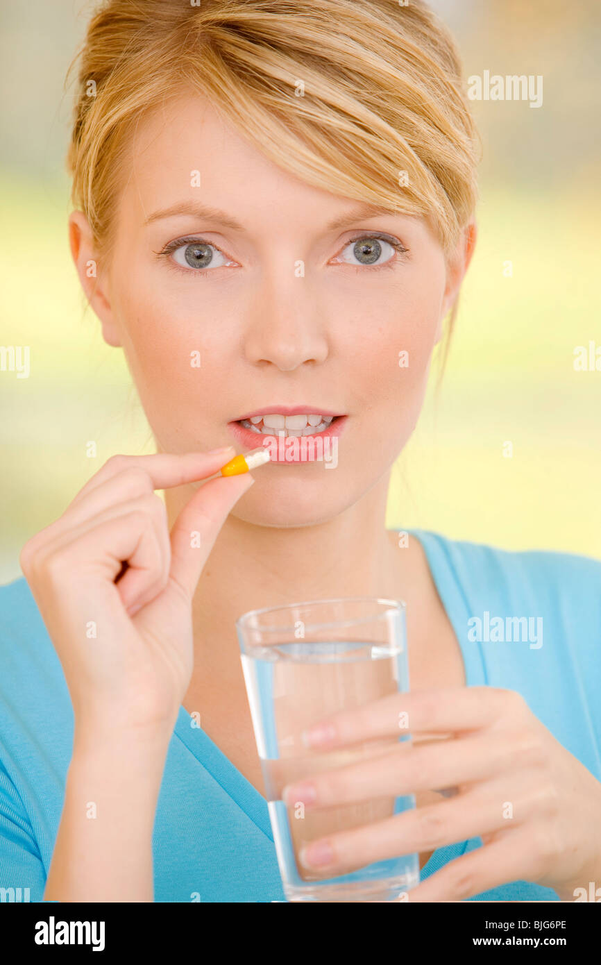 Woman taking the pill hi-res stock photography and images - Alamy