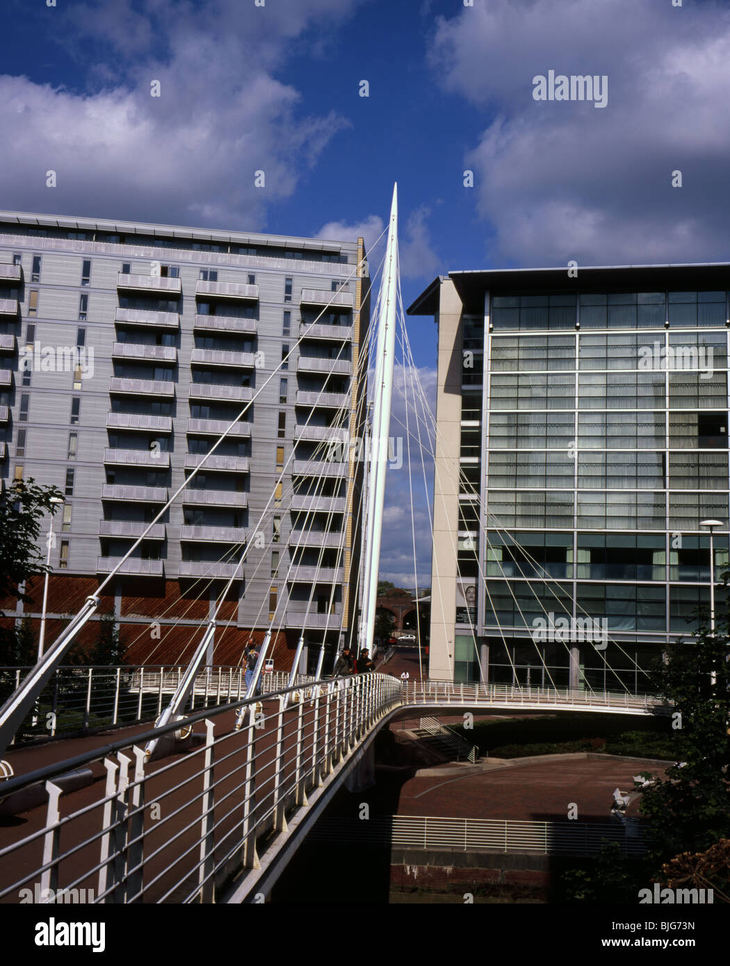 Footbridge spanning The River Irwell with The Lowry Hotel in the ...