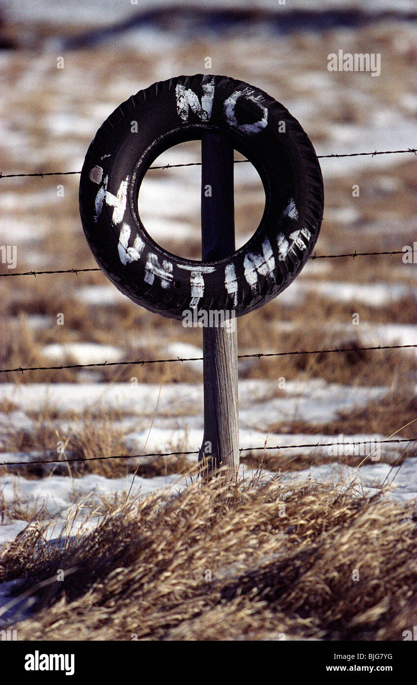 A No Hunting sign written on an old tire Stock Photo - Alamy