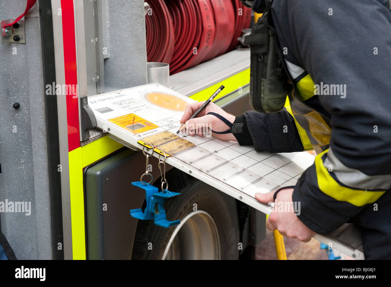 Fireman completing BA tally board FULLY MODEL RELEASED Stock Photo - Alamy