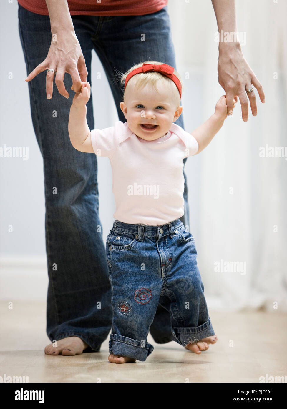 baby girl learning to walk Stock Photo - Alamy