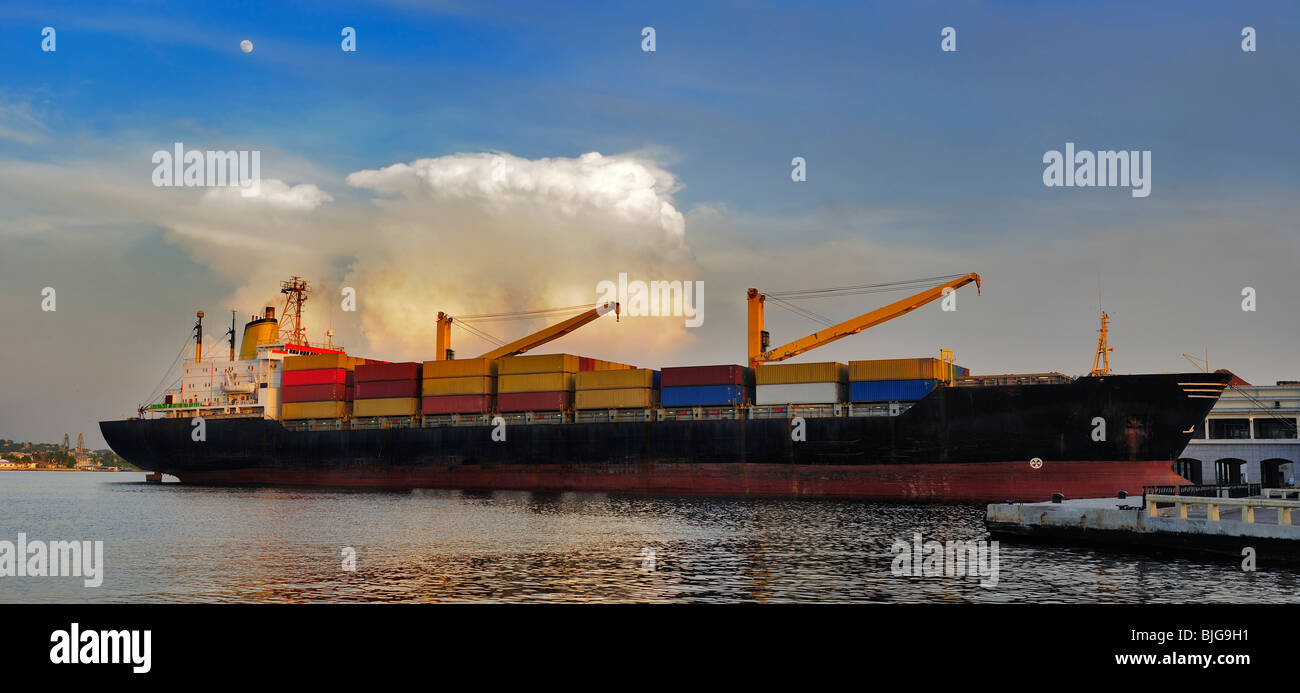 Panoramic view of container cargo ship docked in Havana bay at sunset ...