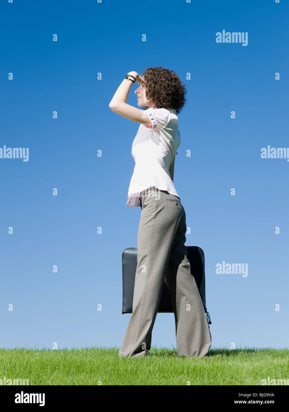 Woman standing with a briefcase hi-res stock photography and images - Alamy