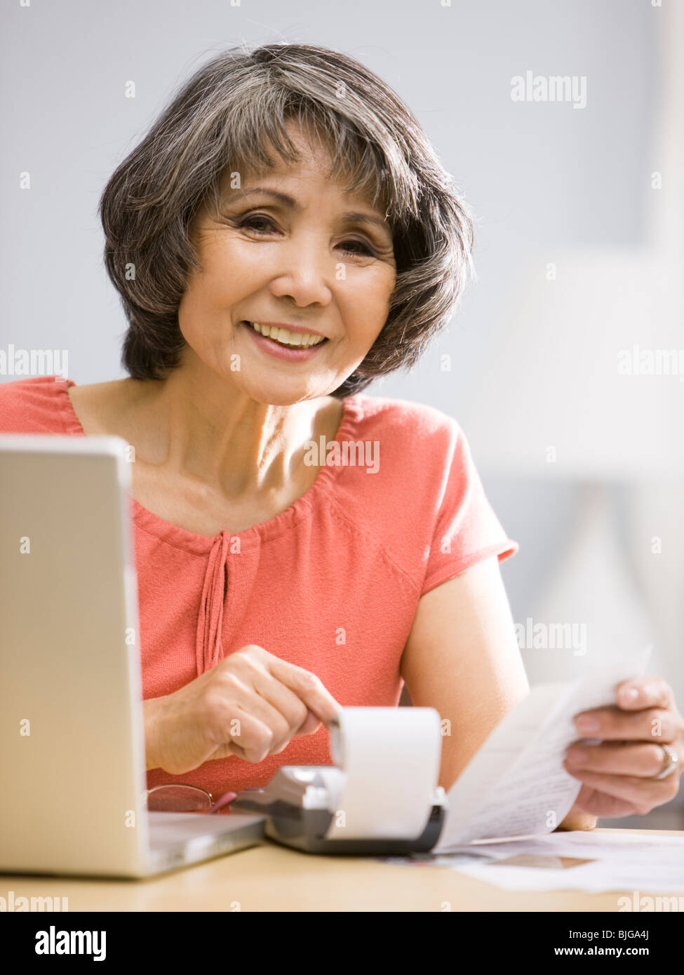 senior woman adding things up Stock Photo - Alamy