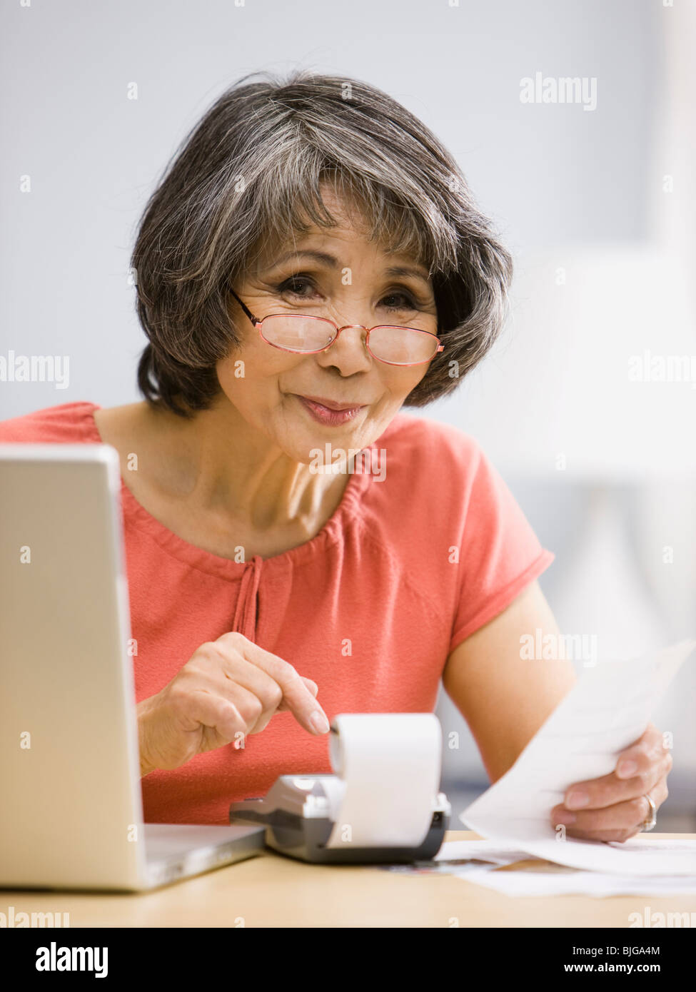 senior woman adding things up Stock Photo - Alamy