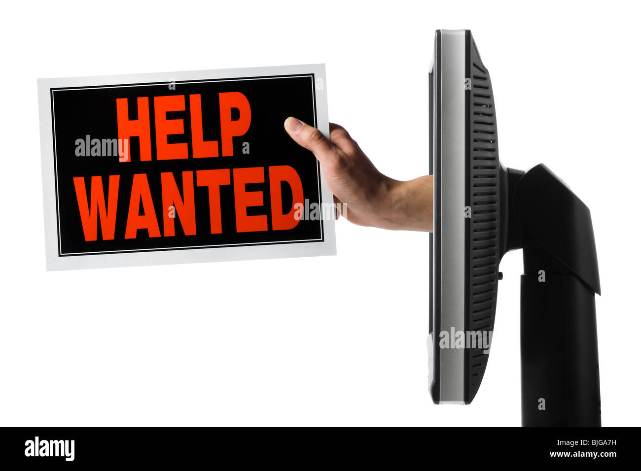 hand coming out of a computer with a help wanted sign Stock Photo - Alamy