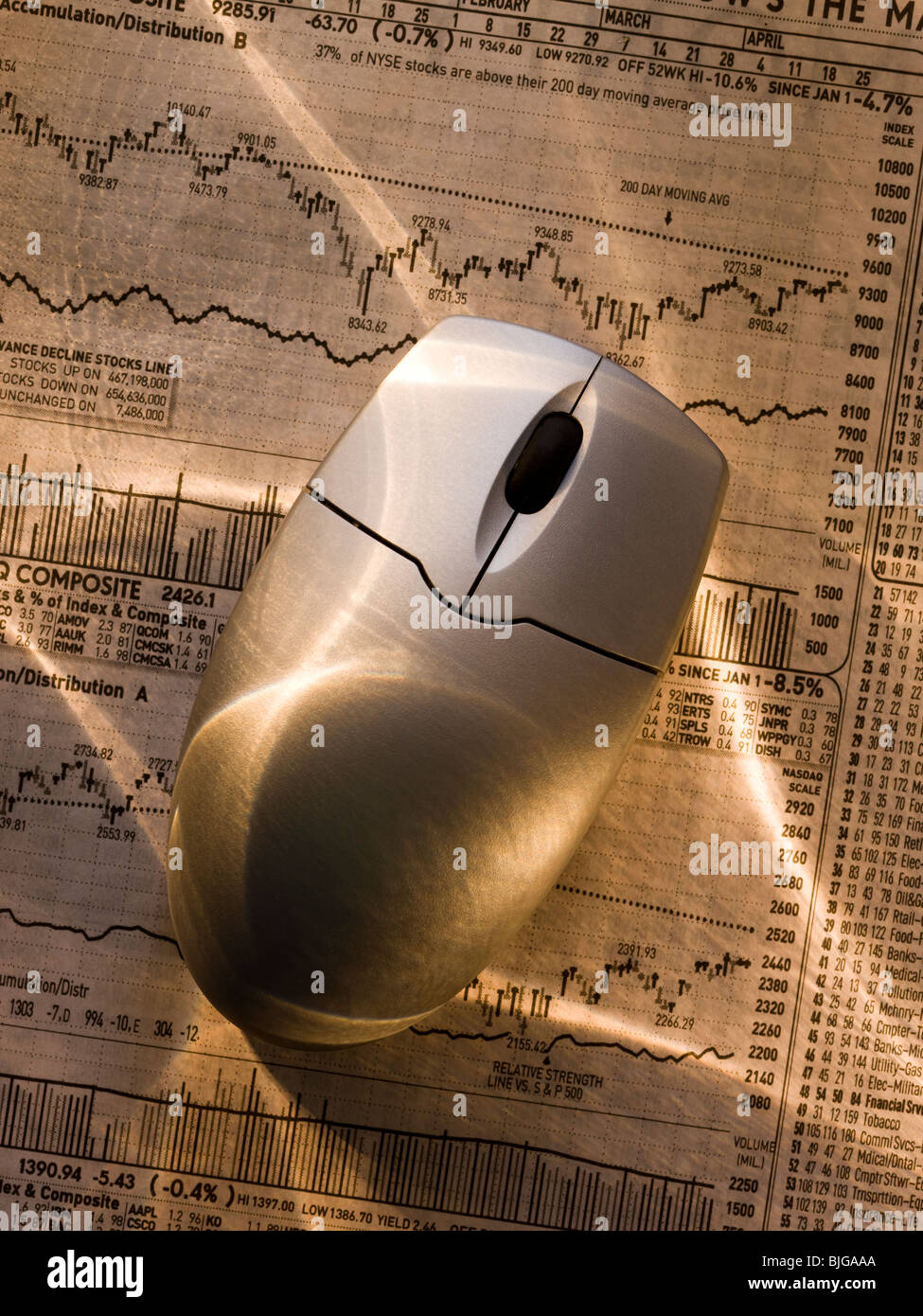 computer mouse on the stock report Stock Photo - Alamy