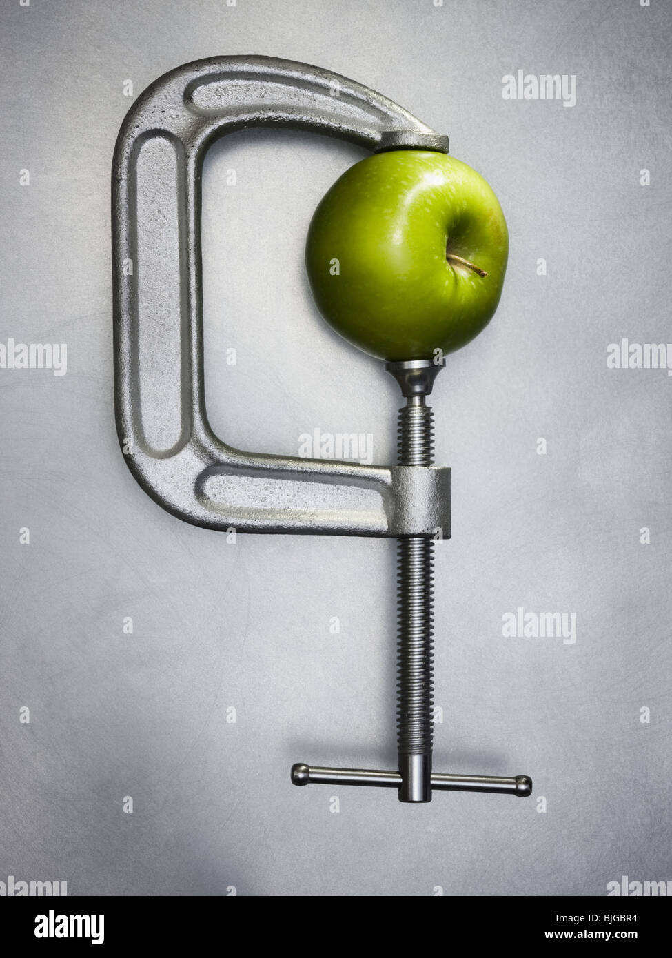 green apple in a clamp Stock Photo - Alamy