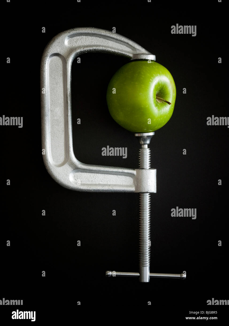 green apple in a clamp Stock Photo - Alamy