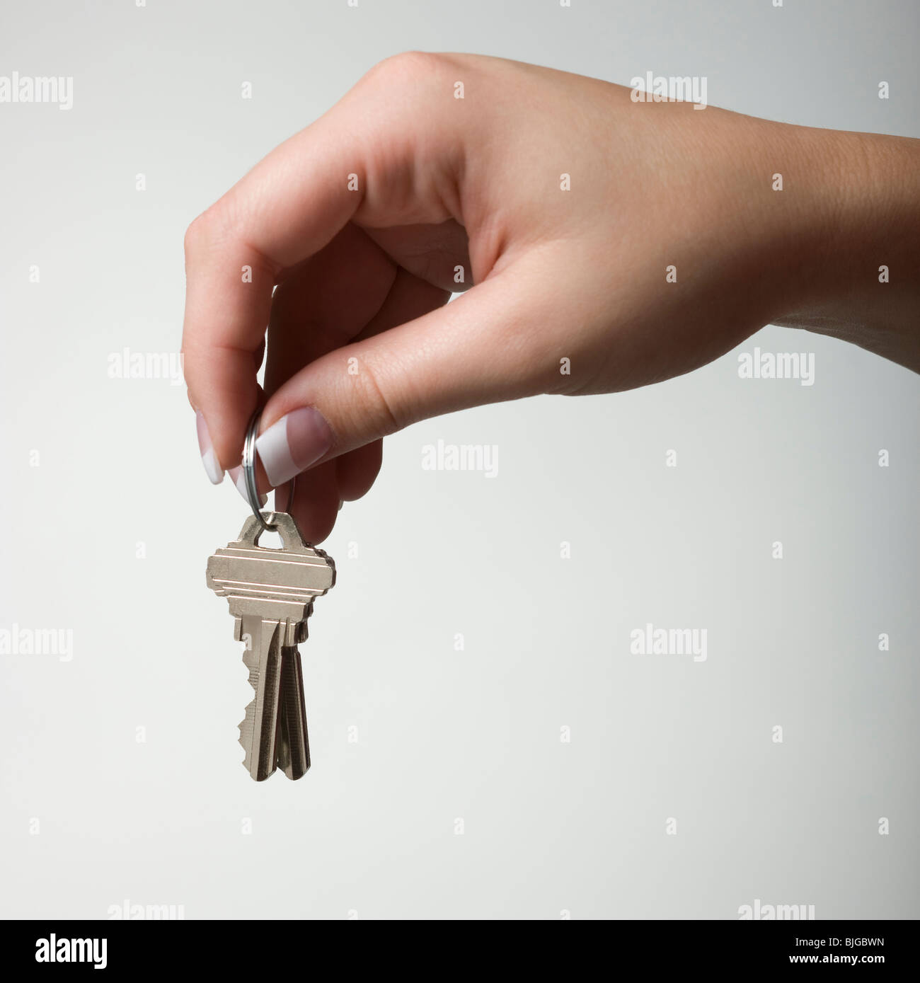 Hand holding keys Stock Photo - Alamy