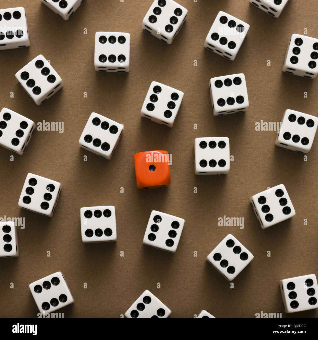 orange die among multiple white dice Stock Photo - Alamy