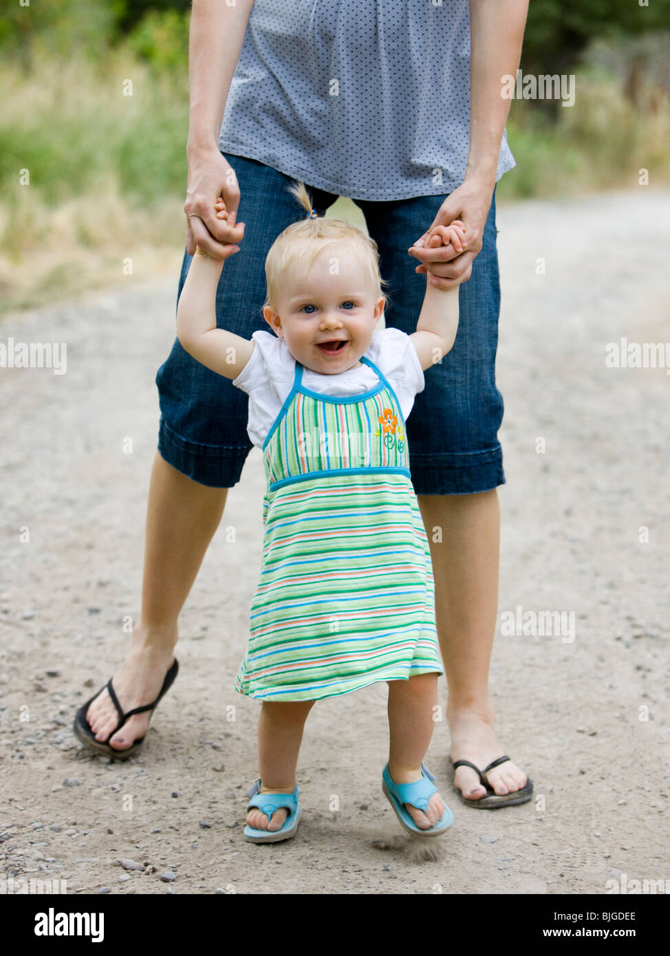mother and baby girl learning to walk Stock Photo - Alamy