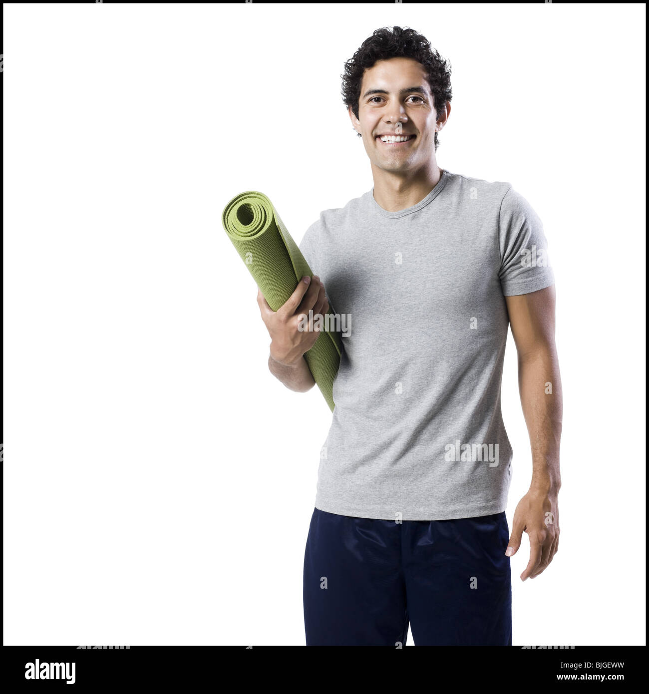 man holding a yoga mat Stock Photo - Alamy