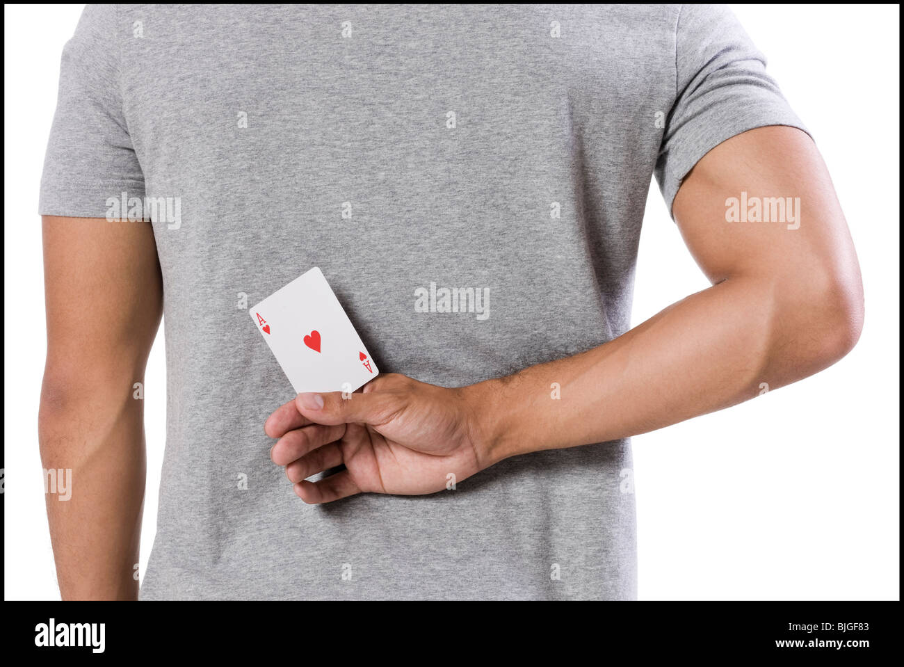 man holding an ace card behind his back Stock Photo - Alamy