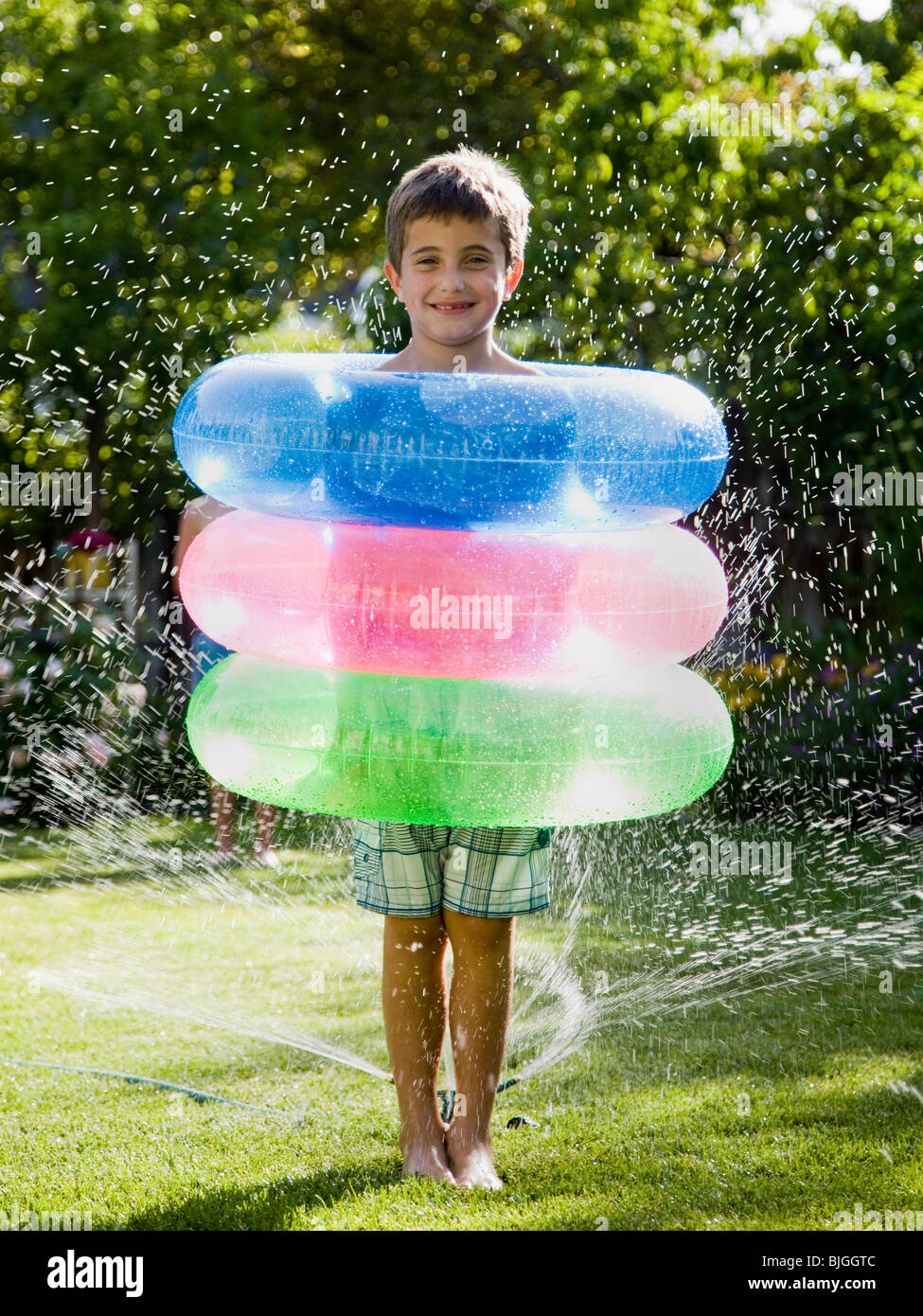 boy with three inner tubes Stock Photo - Alamy