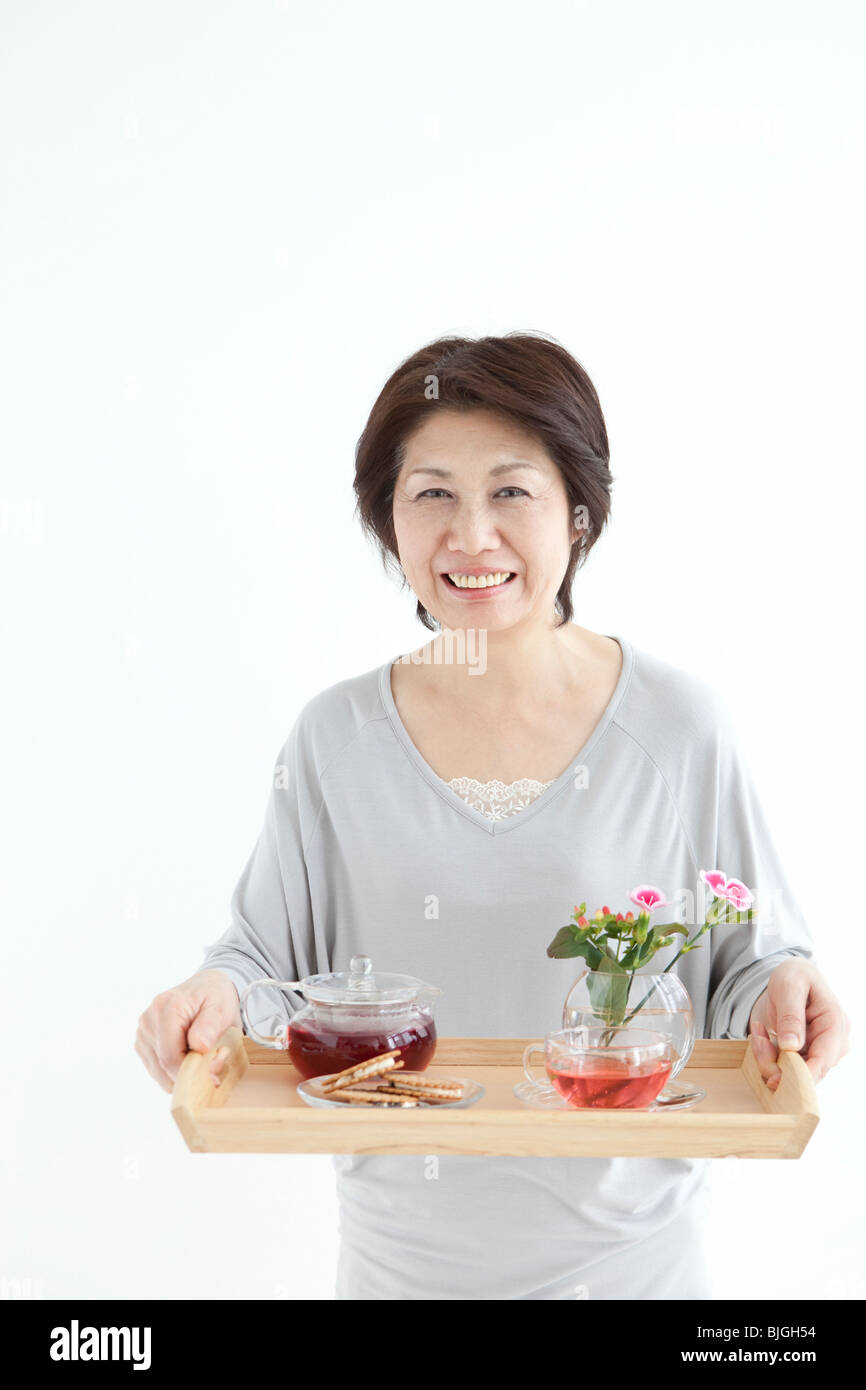 Woman carrying tea tray hi-res stock photography and images - Alamy