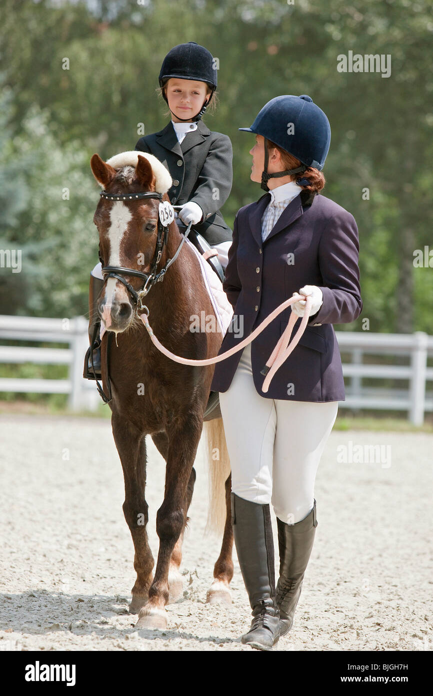 riding lesson: girl on a horse Stock Photo - Alamy