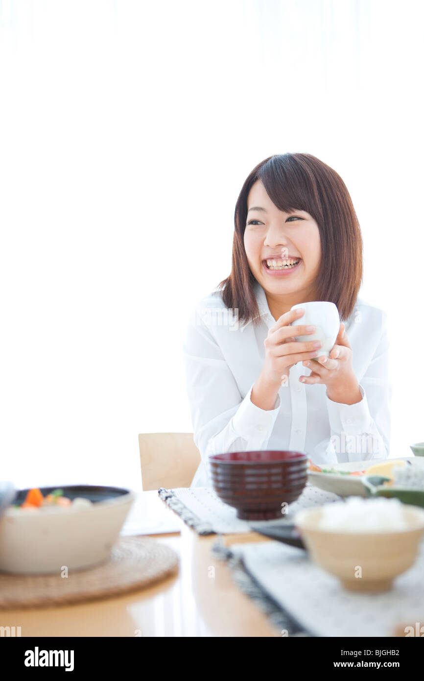 Young woman having a meal Stock Photo - Alamy
