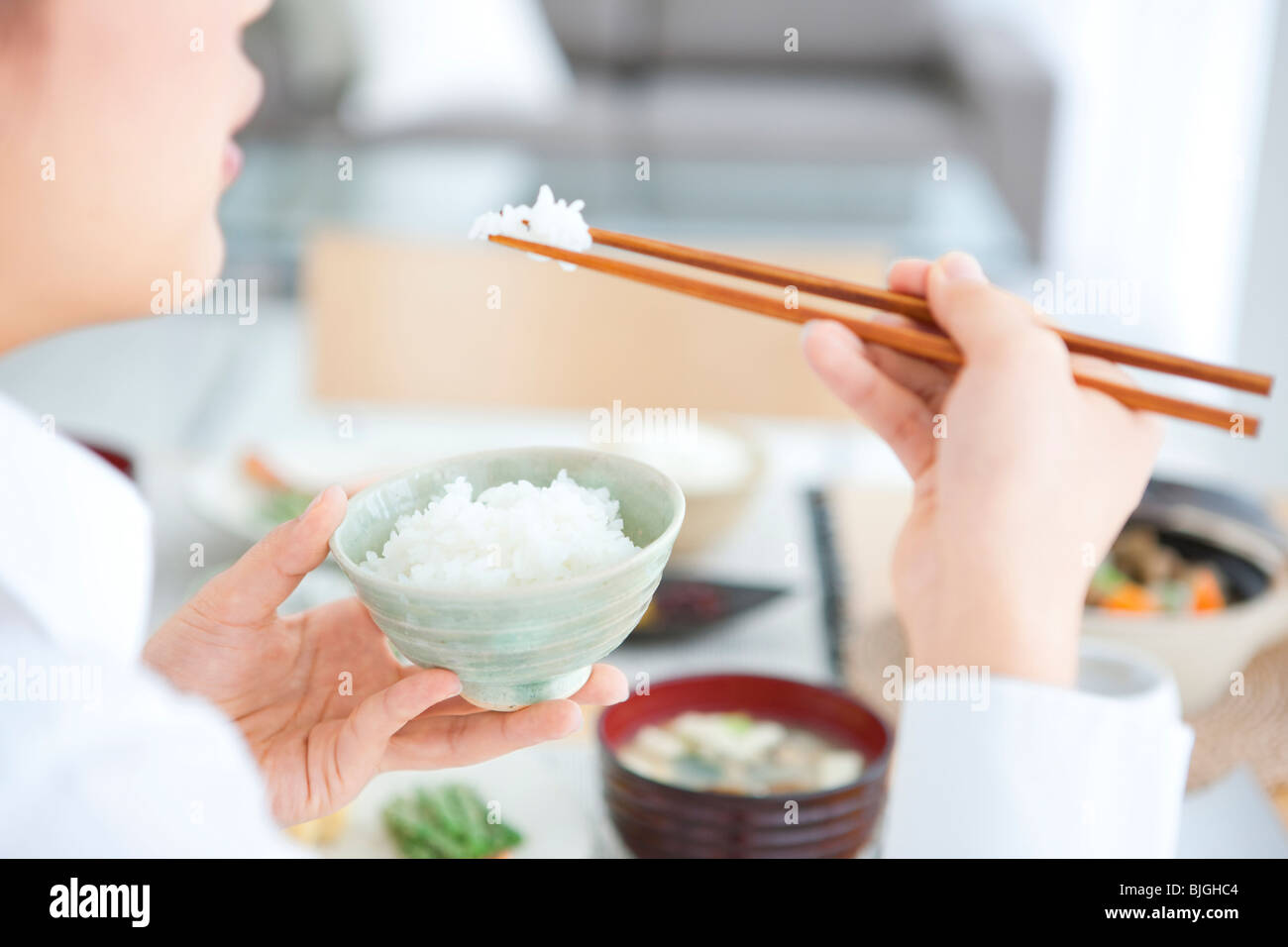 Young woman having a meal Stock Photo - Alamy