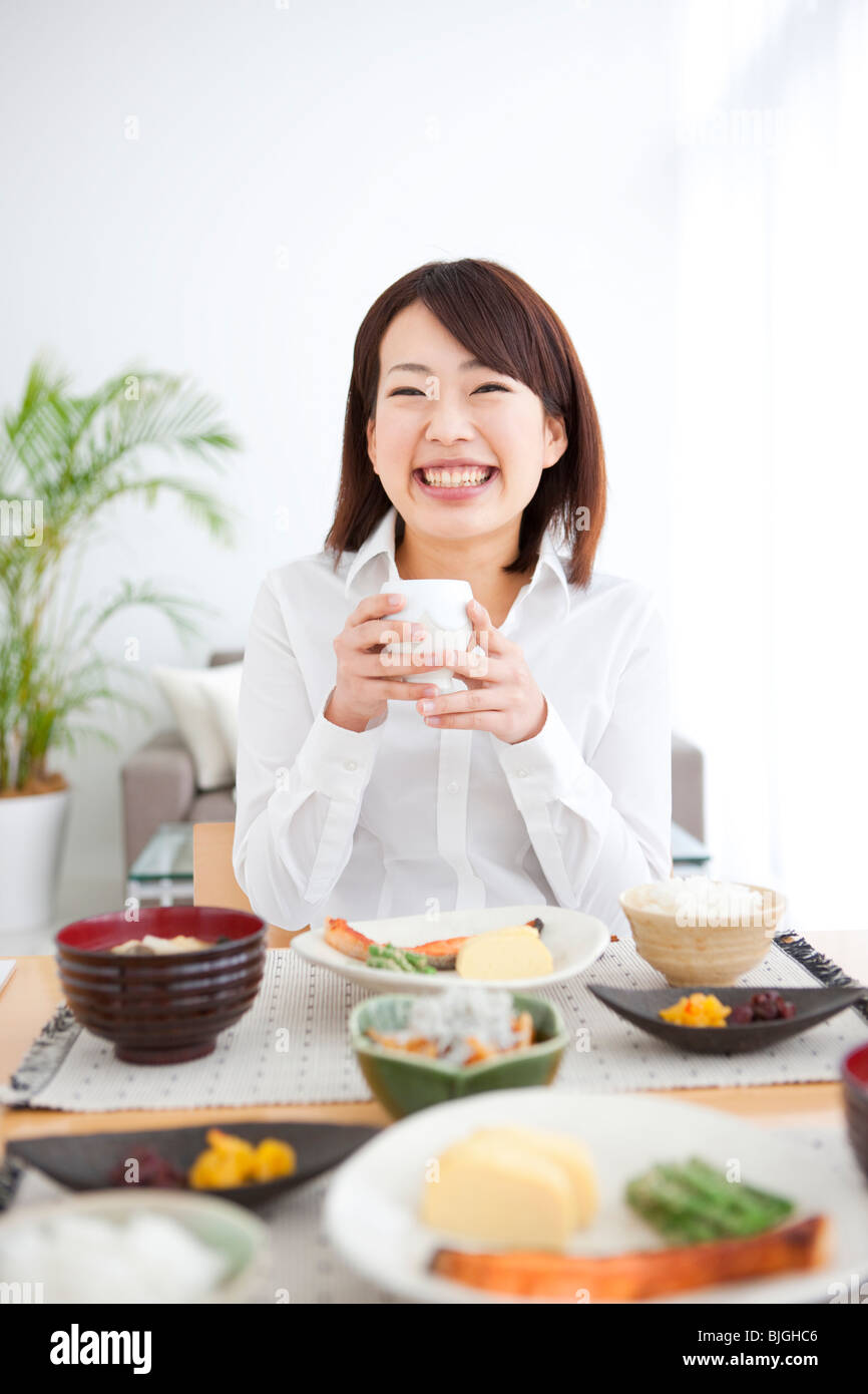 Young woman having a meal Stock Photo - Alamy