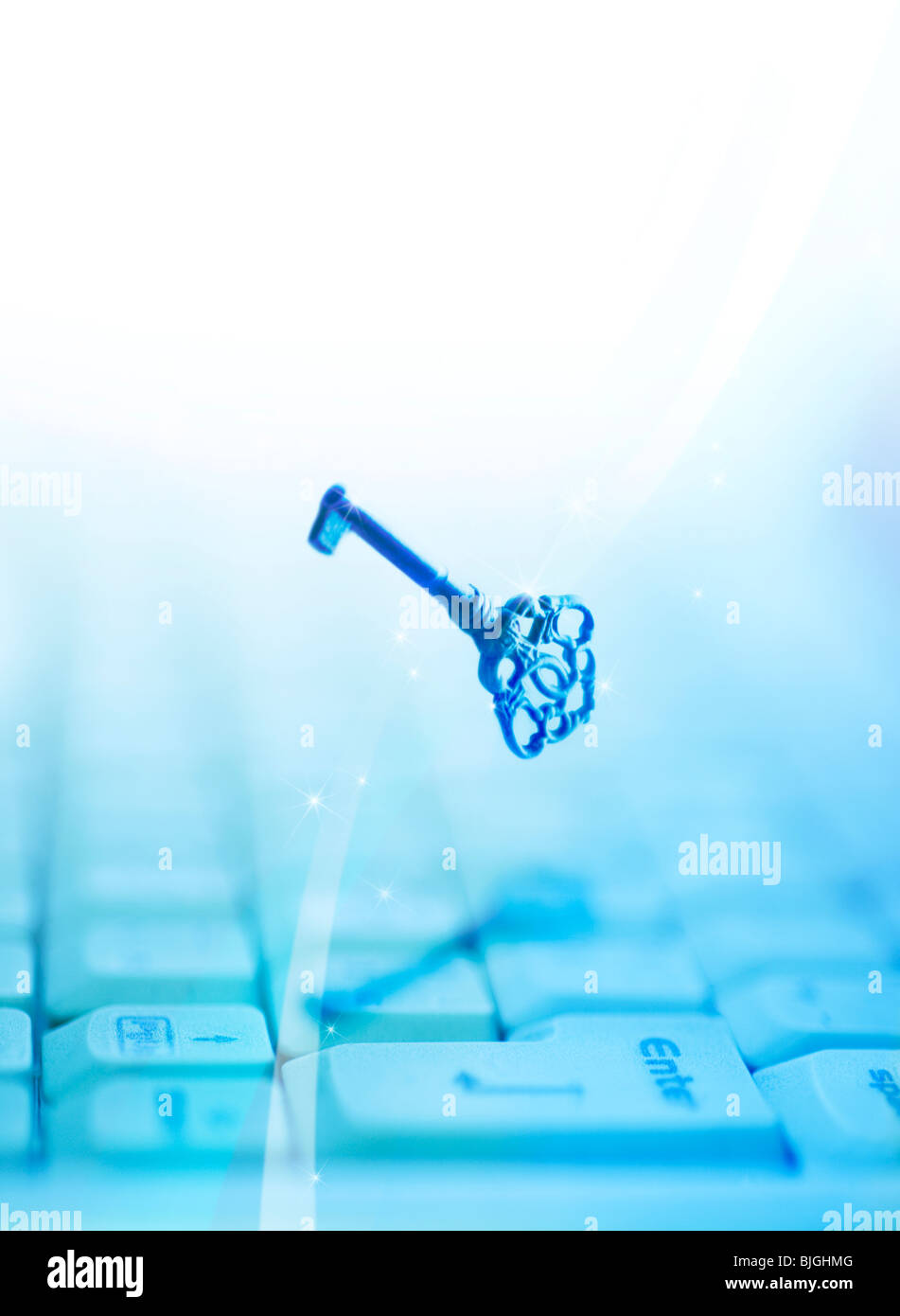 Key hovering over computer keyboard Stock Photo - Alamy