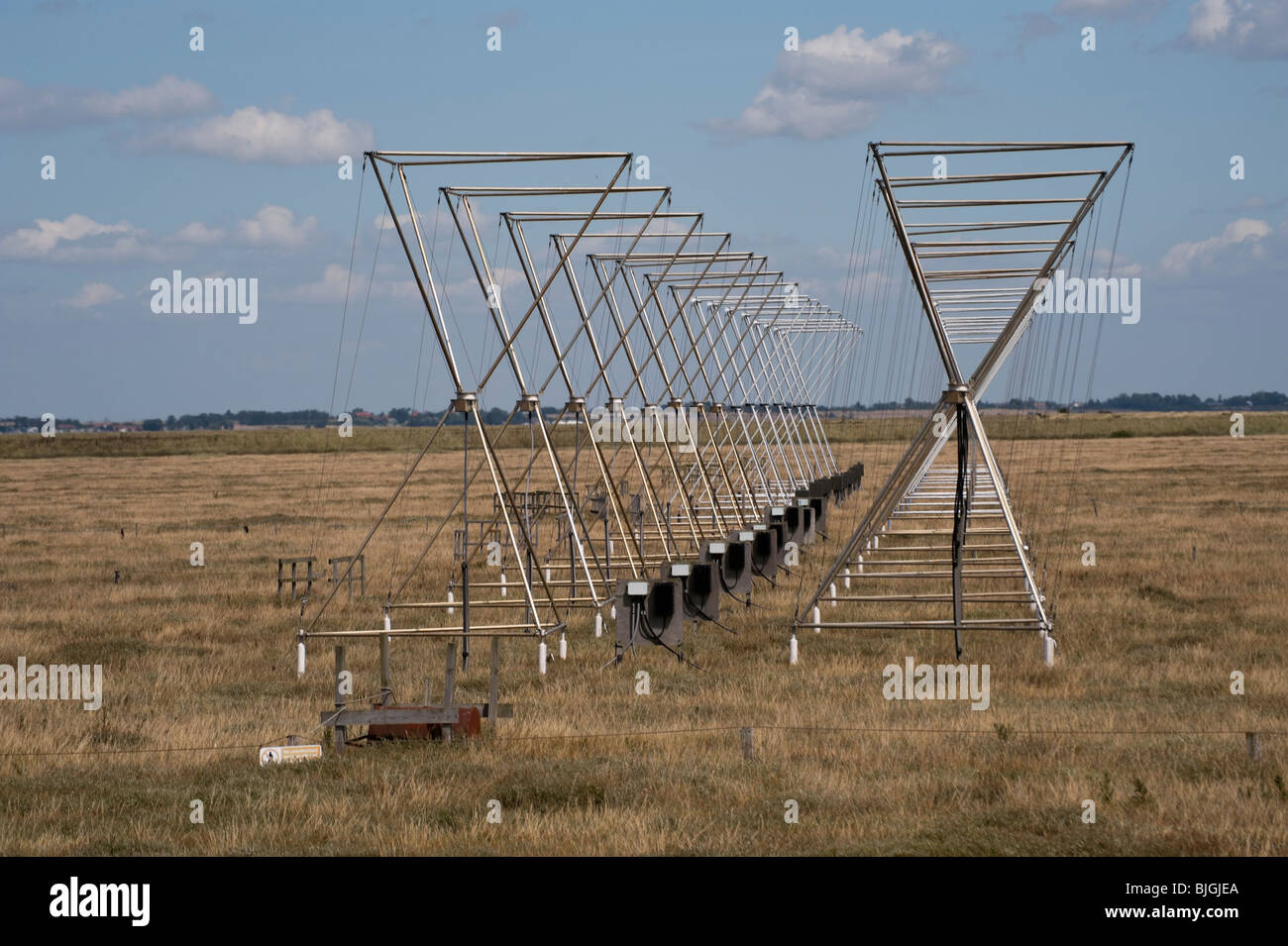 Metal frames with wires on salt marsh on North Sea coast near Bradwell ...