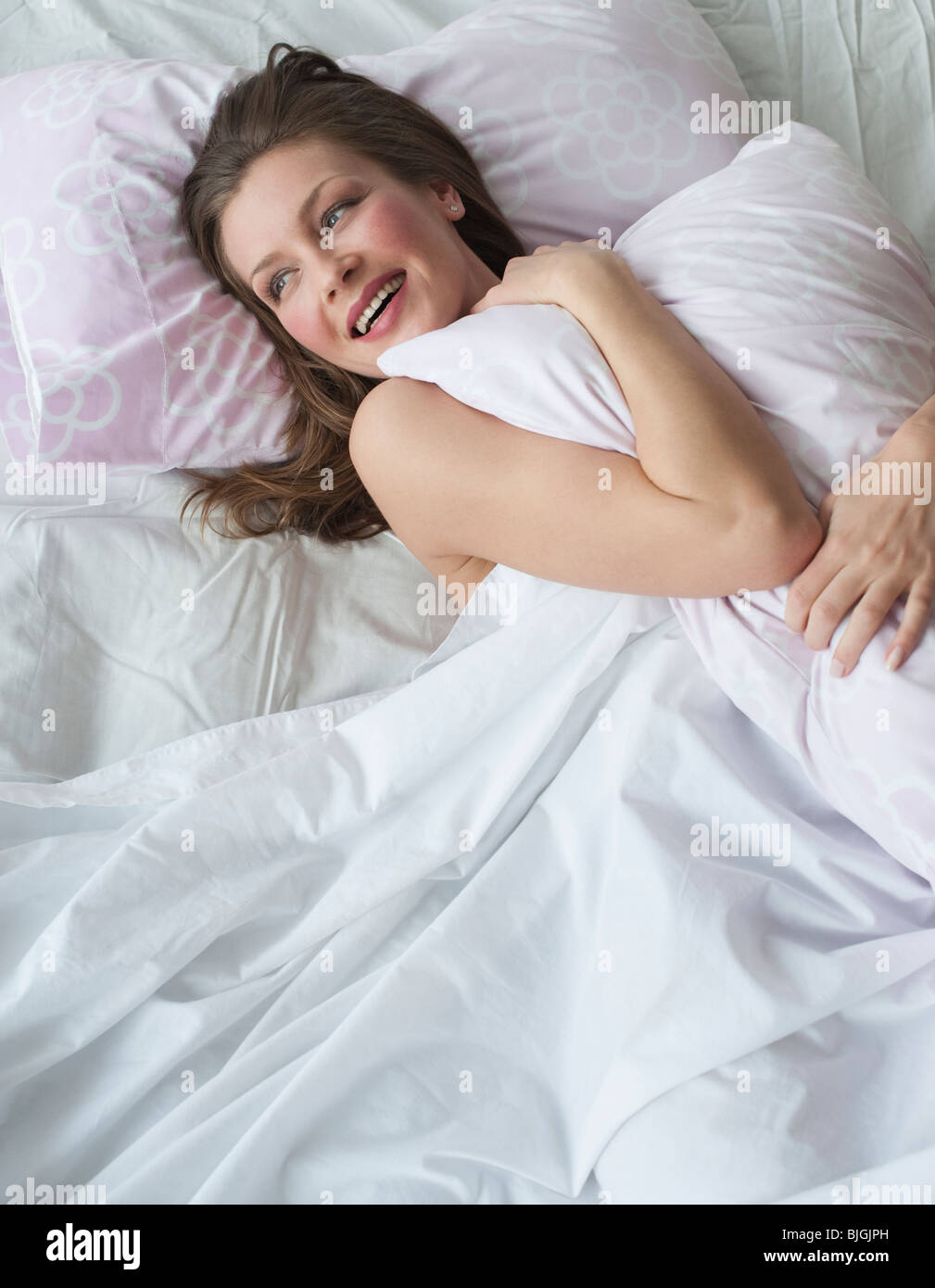 Woman in bed Stock Photo - Alamy