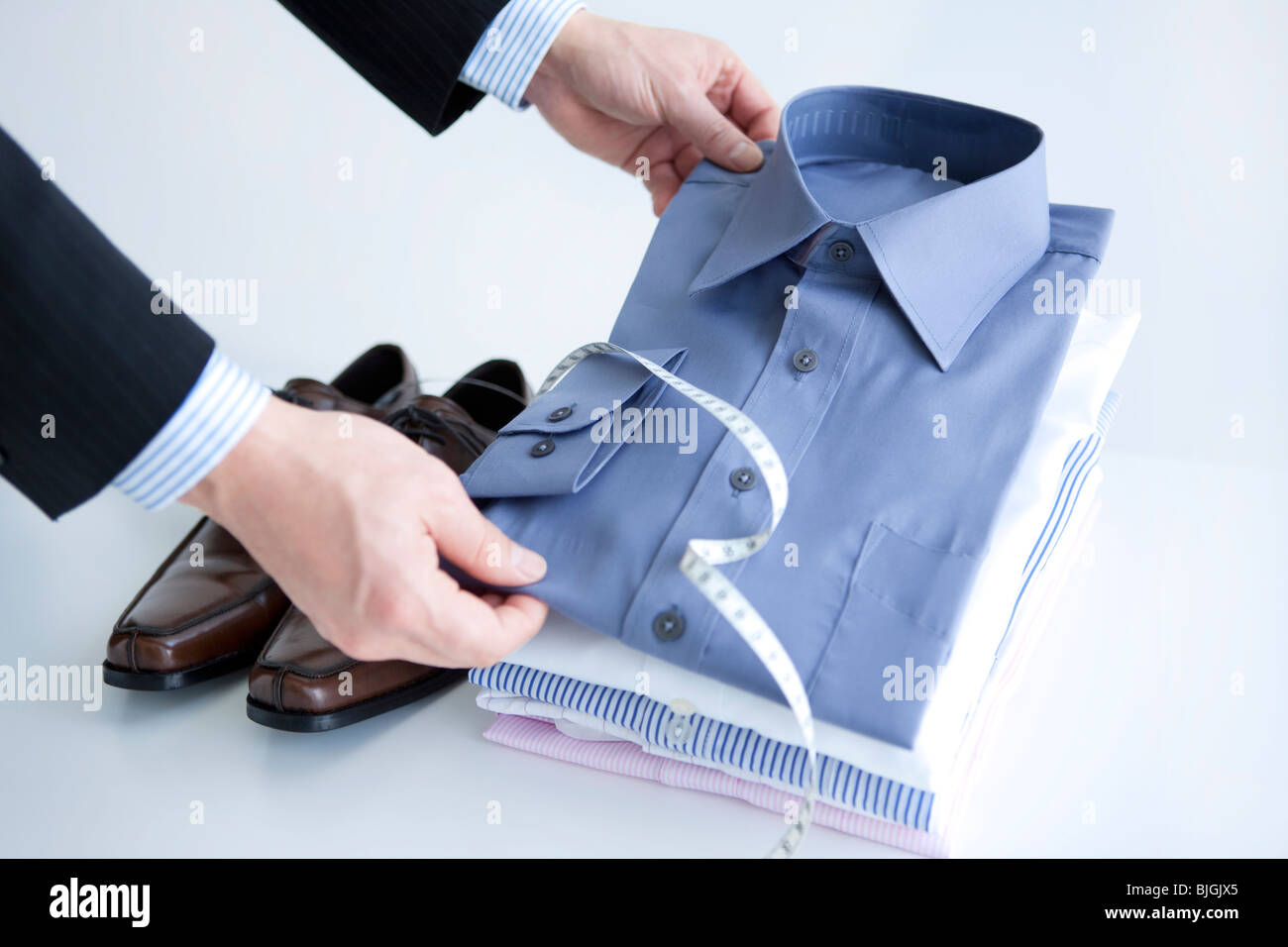 Man folding shirts Stock Photo - Alamy