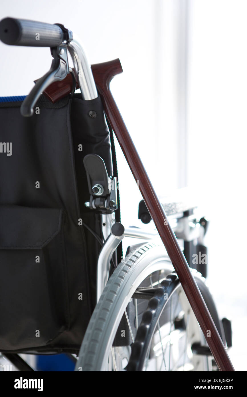 Wheelchair and a cane Stock Photo - Alamy