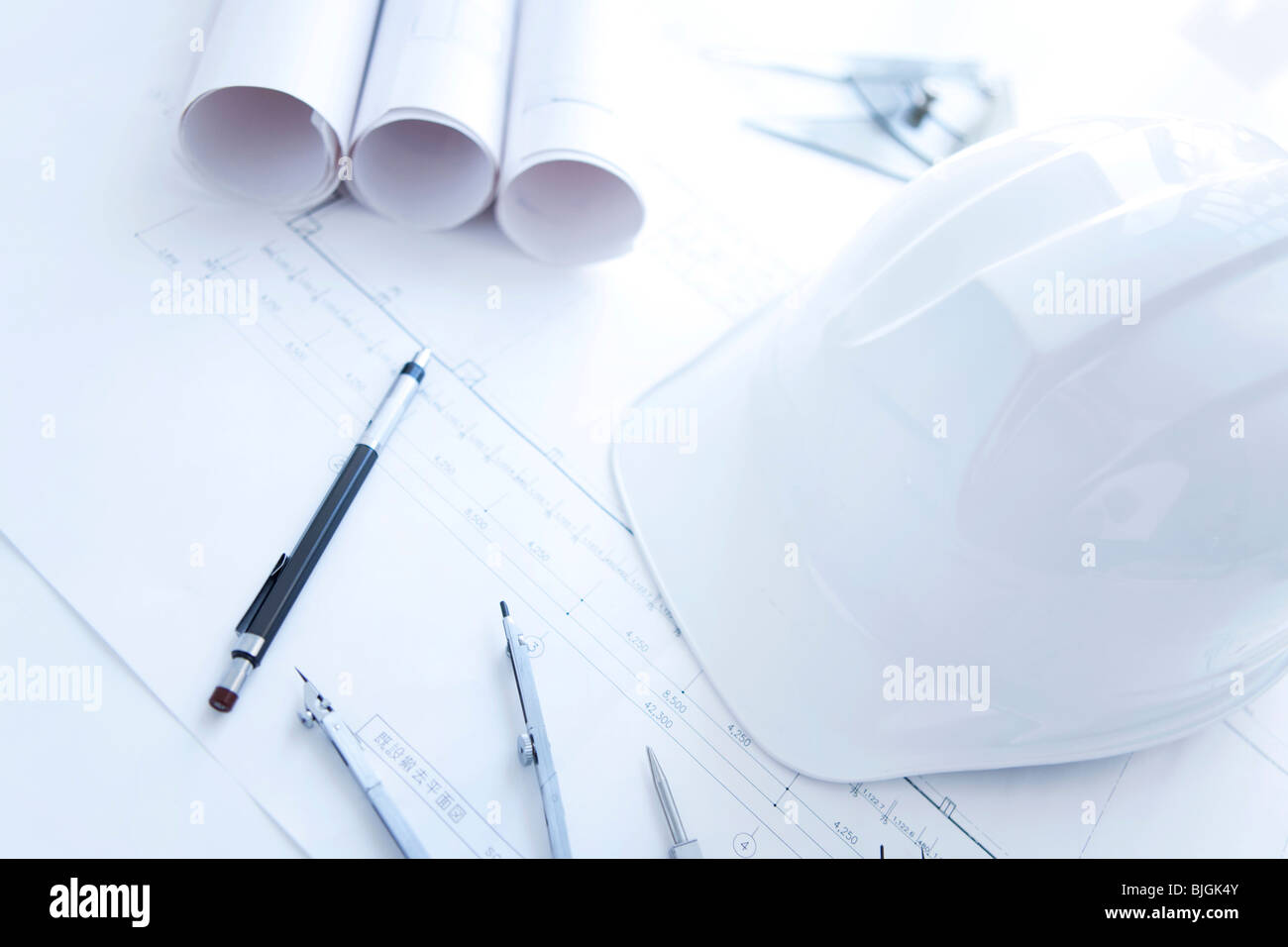 Building plan drawing equipment and a hardhat Stock Photo - Alamy
