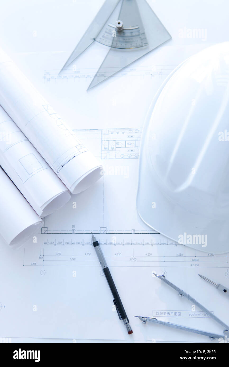 Building plan drawing equipment and a hardhat Stock Photo - Alamy